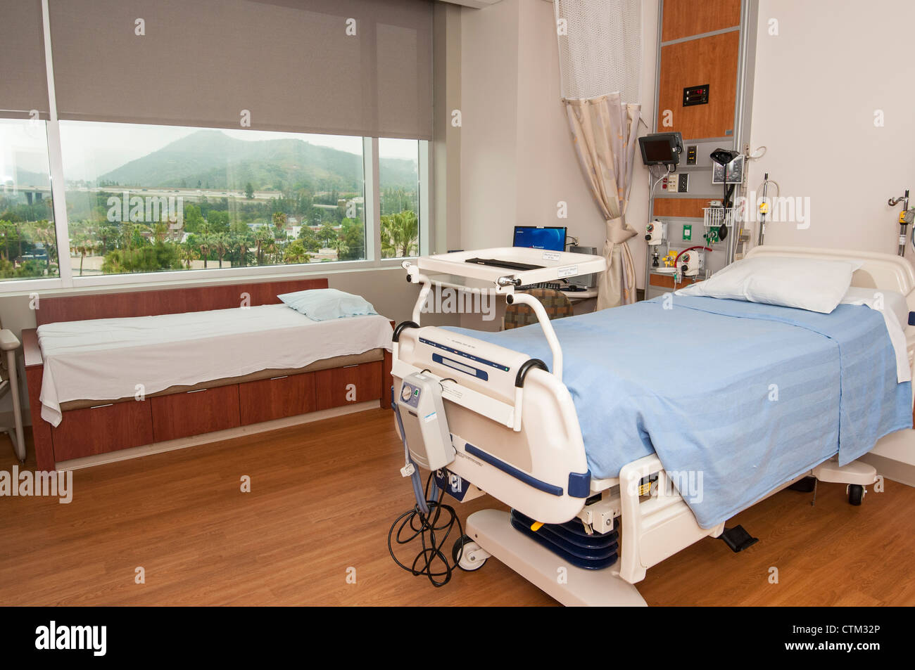 A large modern hospital room with views of the city outside Stock Photo ...