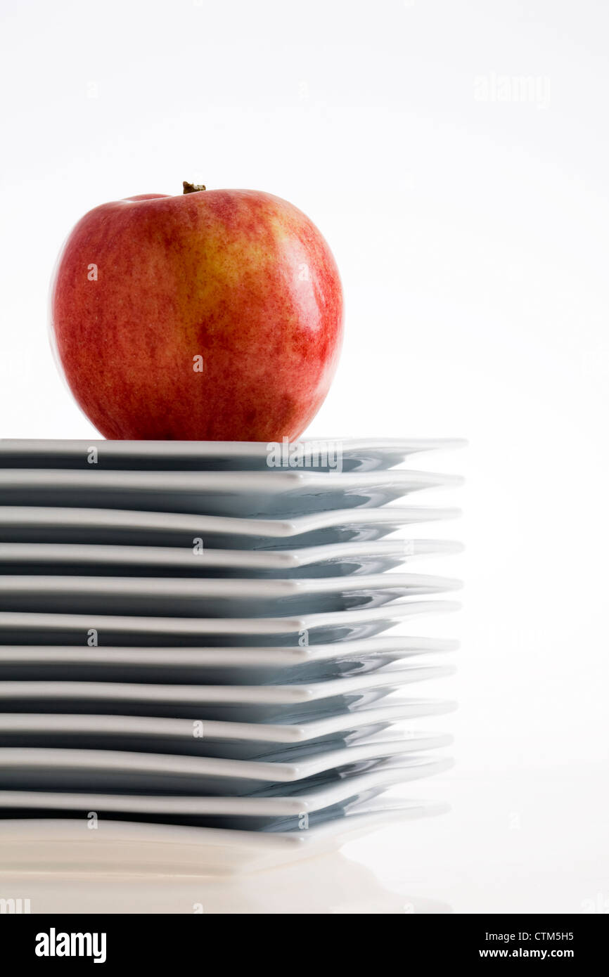 Stack Of White Square Plates With An Apple On Top On A White Background ...