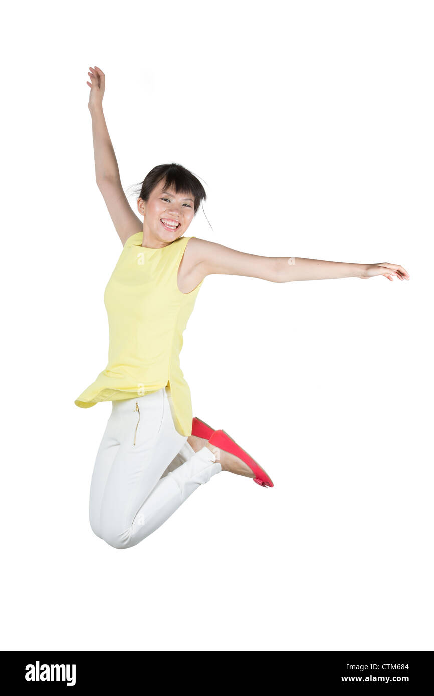 Happy Asian woman jumping for joy. Isolated on a white background Stock ...