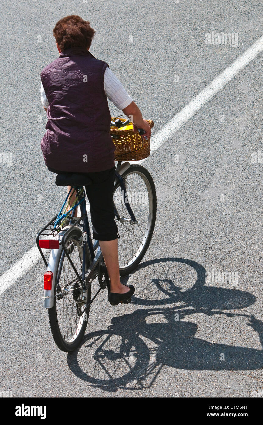 Woman shopper riding bicycle - France Stock Photo - Alamy