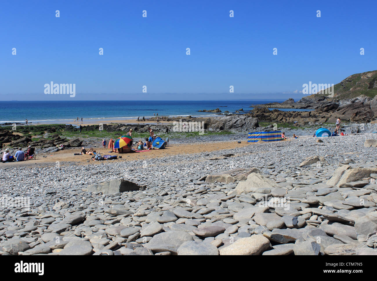 Families sunbathing at Gunwalloe Beach Stock Photo - Alamy