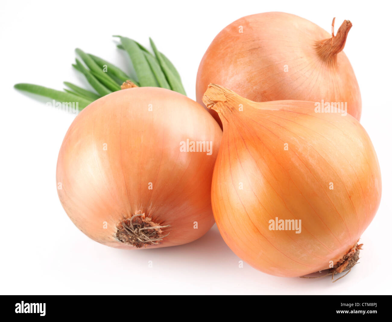 Three onions on a white background Stock Photo - Alamy