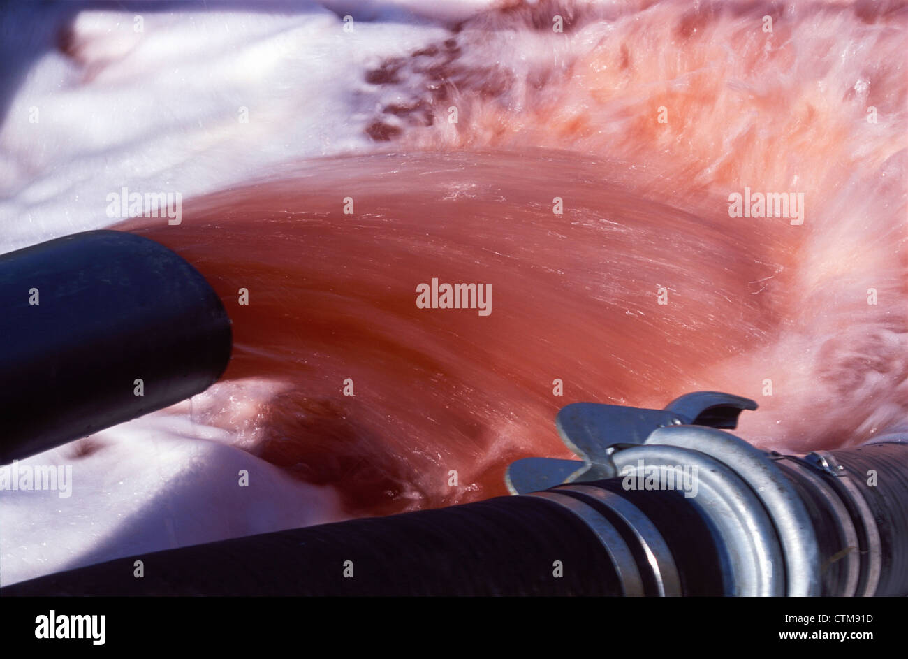 Waste water pipes flushing waste water into tank Stock Photo - Alamy