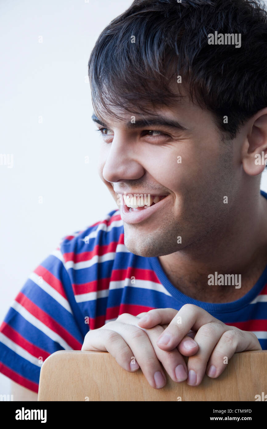 Cheerful young man looking with curiosity Stock Photo - Alamy