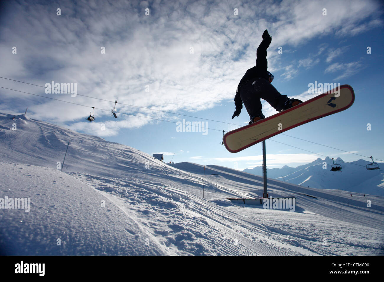 jumping snowboarder facing the sun Stock Photo - Alamy