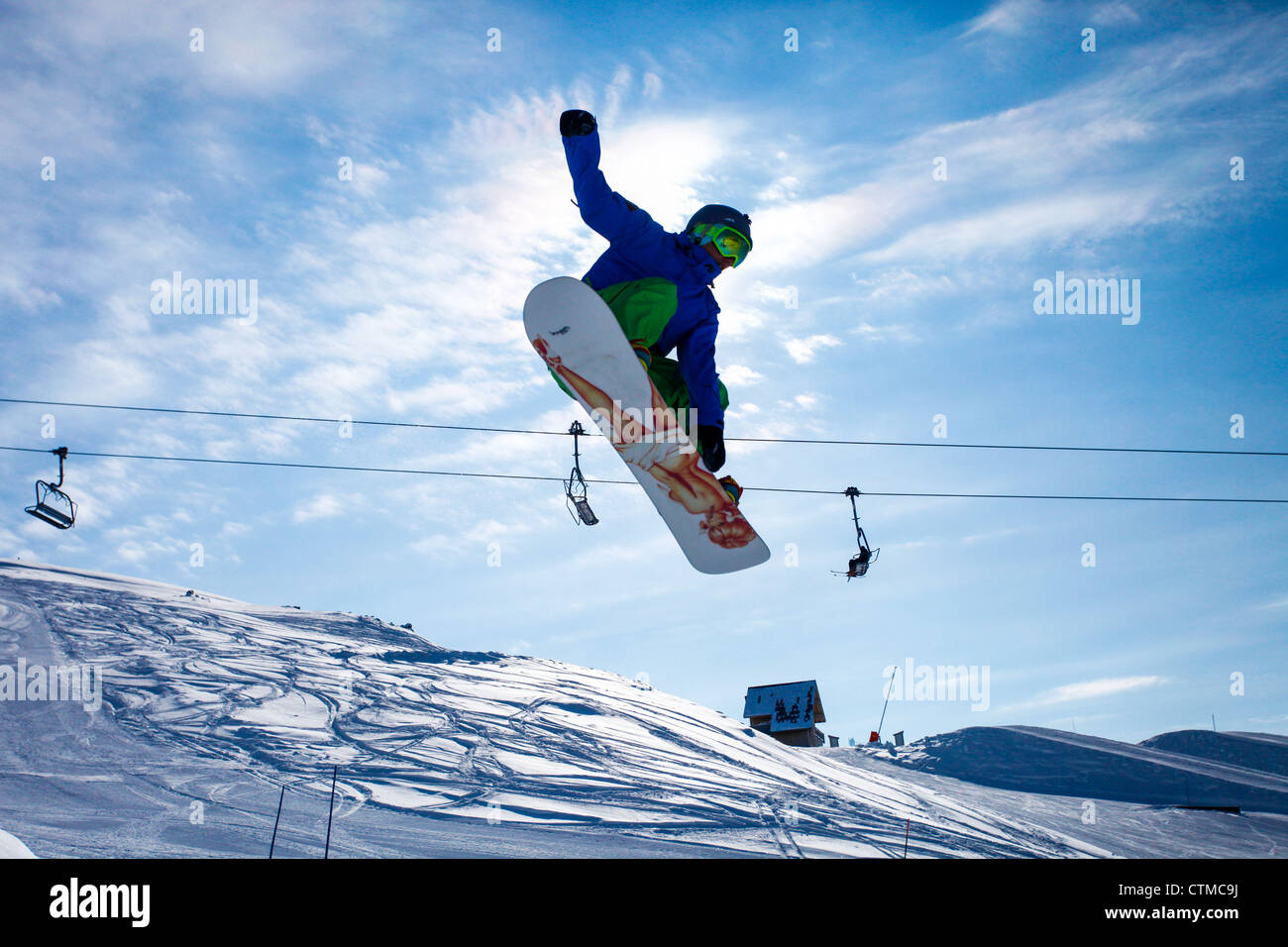 jumping snowboarder facing the sun Stock Photo - Alamy