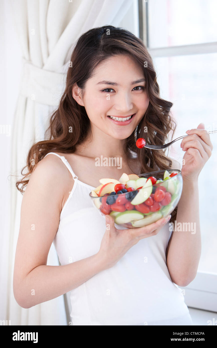 Young woman eating fruit salad Stock Photo - Alamy Young woman eating fruit salad Stock Photo - Alamy