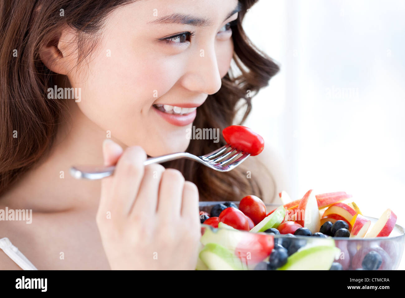 Young woman eating fruit salad Stock Photo - Alamy Young woman eating fruit salad Stock Photo - Alamy