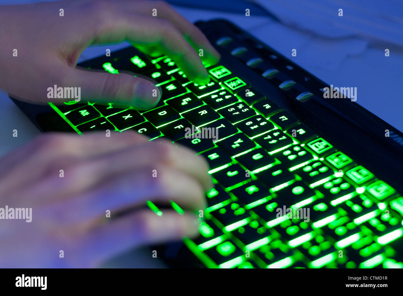 Closeup of hands typing a modern backlit keyboard Stock Photo - Alamy