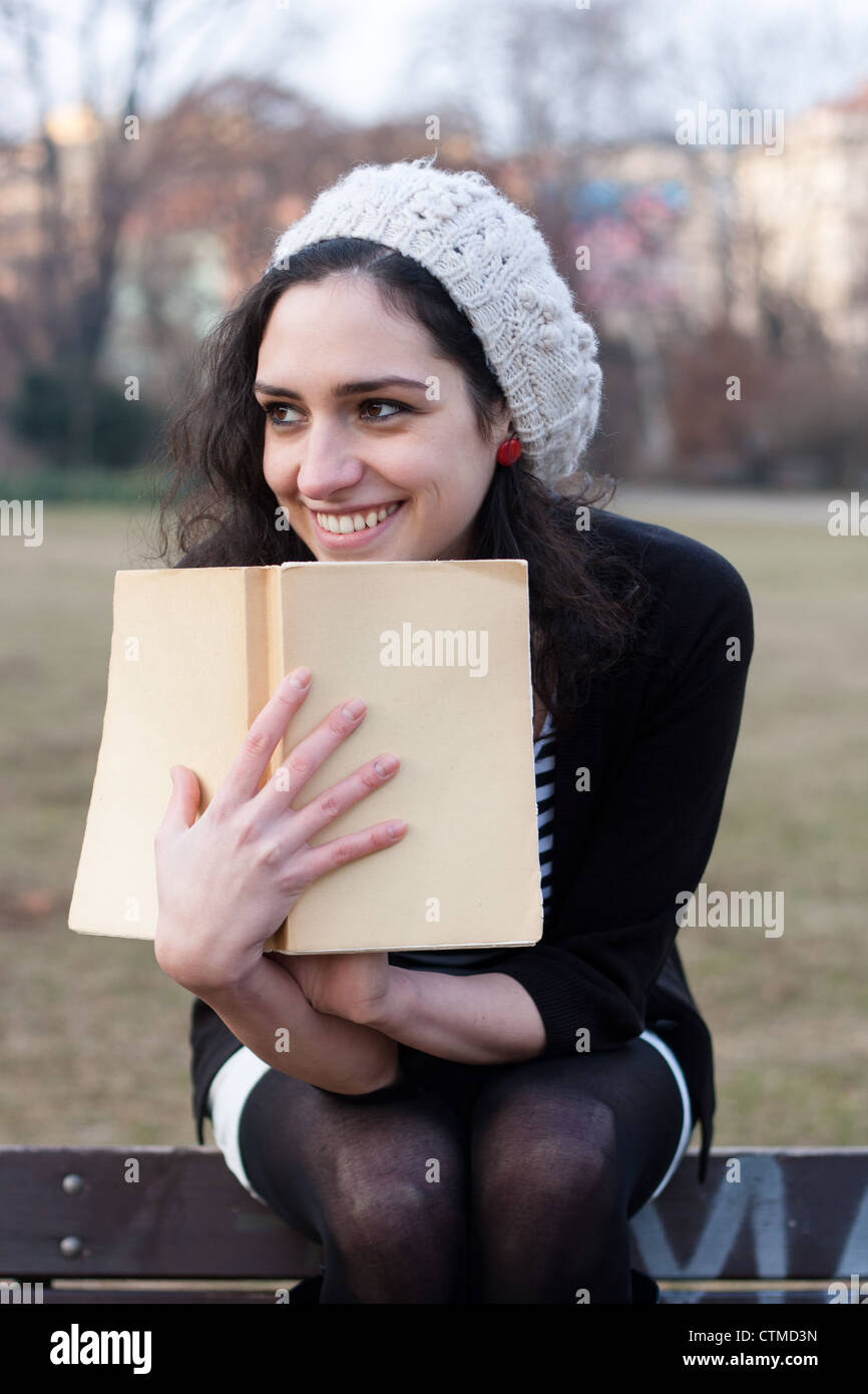 Pretty young student reading a book outside on the campus Stock Photo ...
