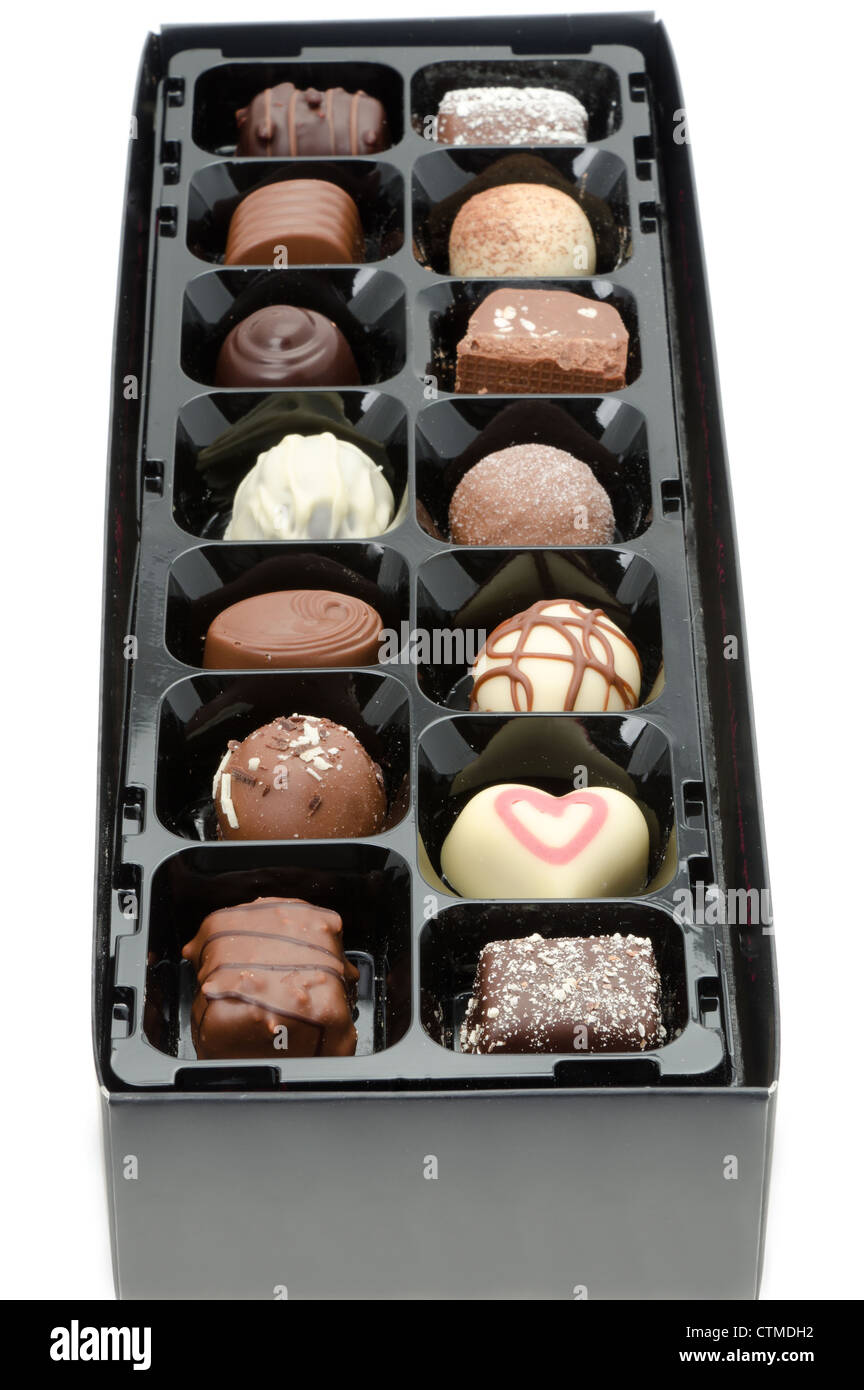 An opened box of luxury Belgian chocolates - studio shot with a white ...