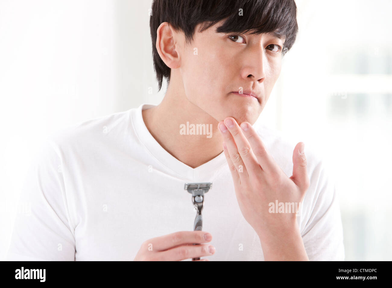Young man doing shaving Stock Photo - Alamy