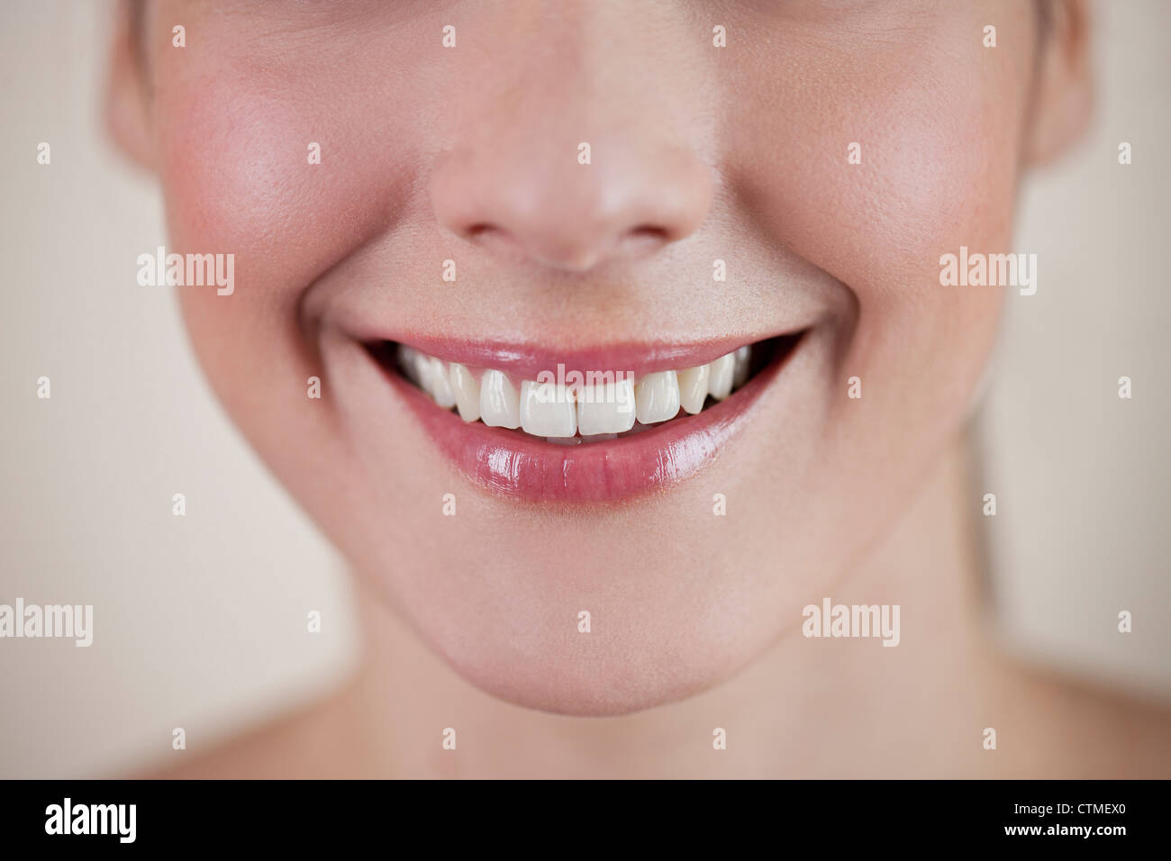 Close-up of a young woman smiling, front view Stock Photo - Alamy