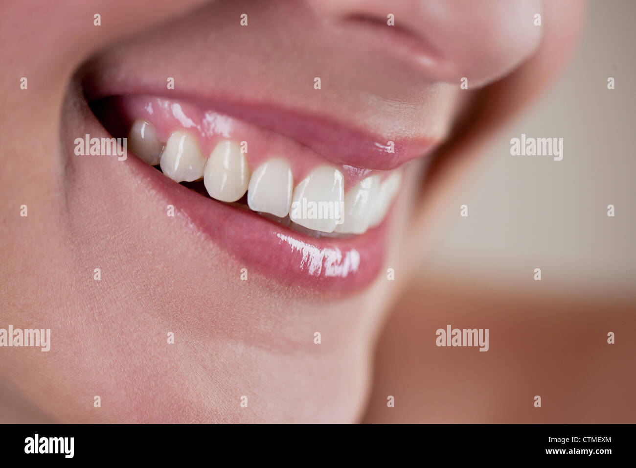 Close-up of a young woman smiling, side view Stock Photo - Alamy