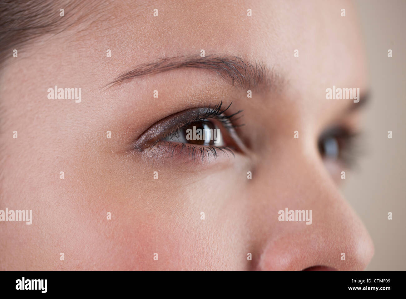 Close-up of a young woman with brown eyes, side view Stock Photo - Alamy