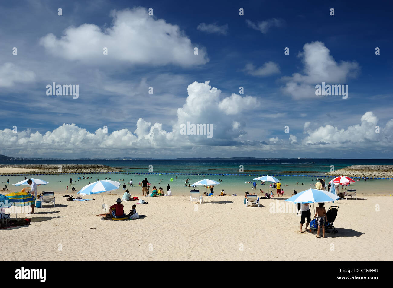 Beach goers enjoy a little fun in the sun during an event in Okinawa ...