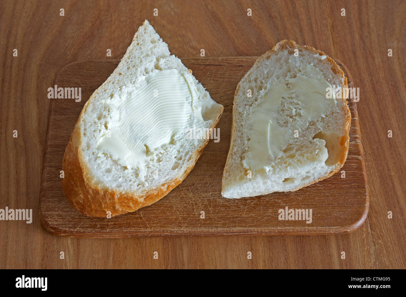 Buttered Fresh stick bread Stock Photo - Alamy