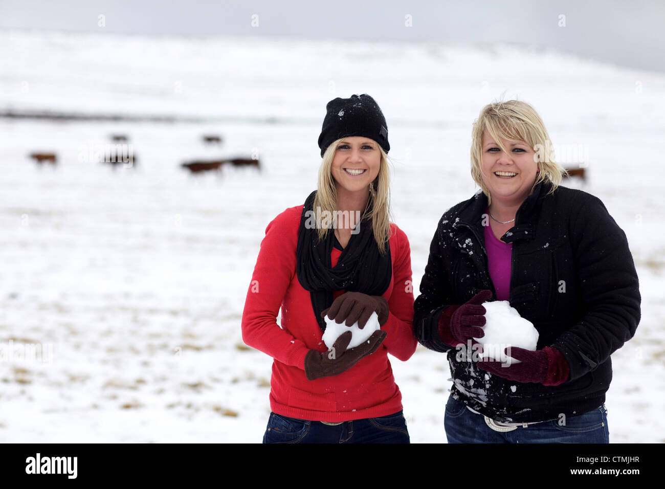 Two young women holding large snowballs, Kamberg, KwaZulu-Natal, South ...