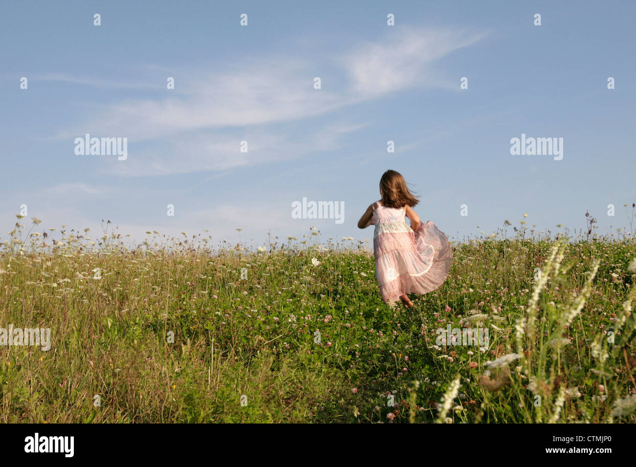 Girl running in field, Western Cape Province, South Africa Stock Photo ...