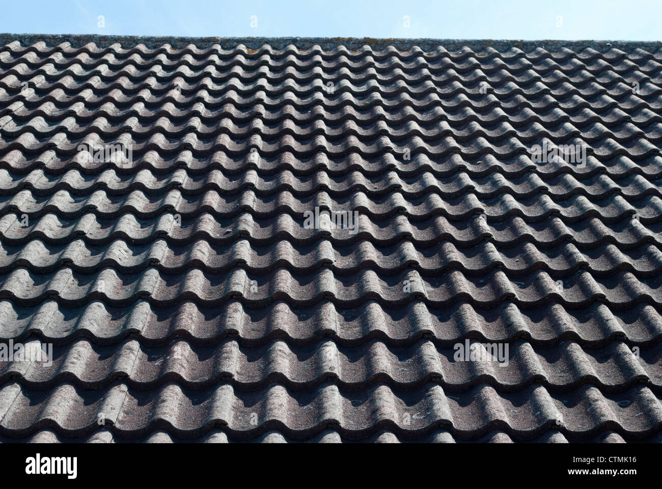 Sloped tiled roof against sliver of pale sky Stock Photo - Alamy