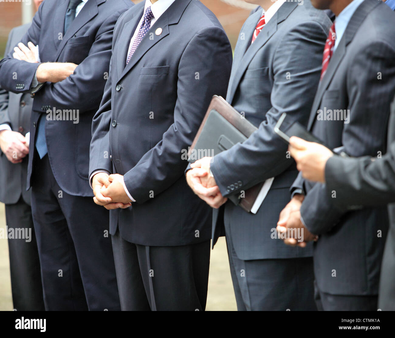 Five business men wearing suits with hands crossed waiting Stock Photo ...