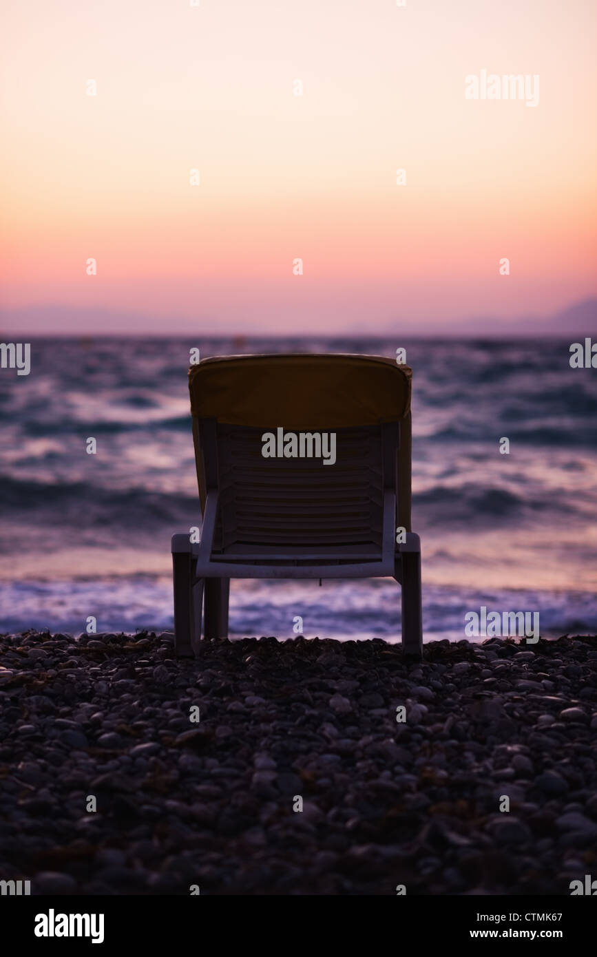 Lonely sun bed on sea coast in dusk Stock Photo - Alamy