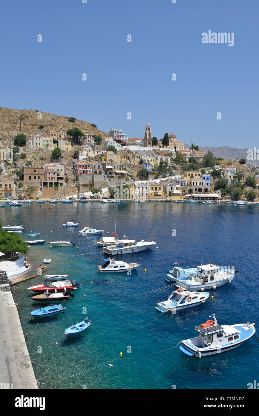 Small boat moored in front of hotels and cafès with the Harani quay in ...