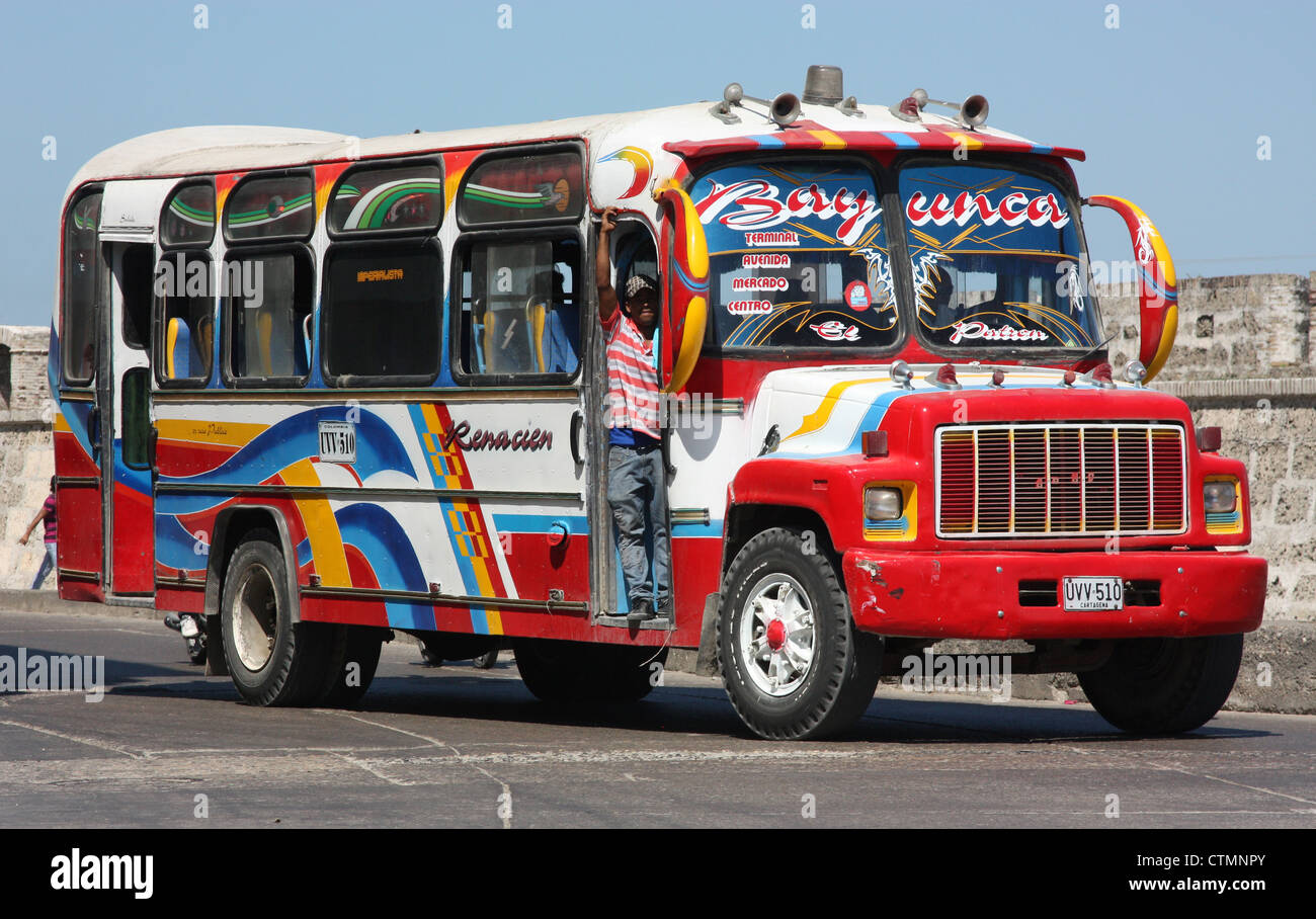 Brightly decorated local bus (chicken bus) picking up passengers in Old ...