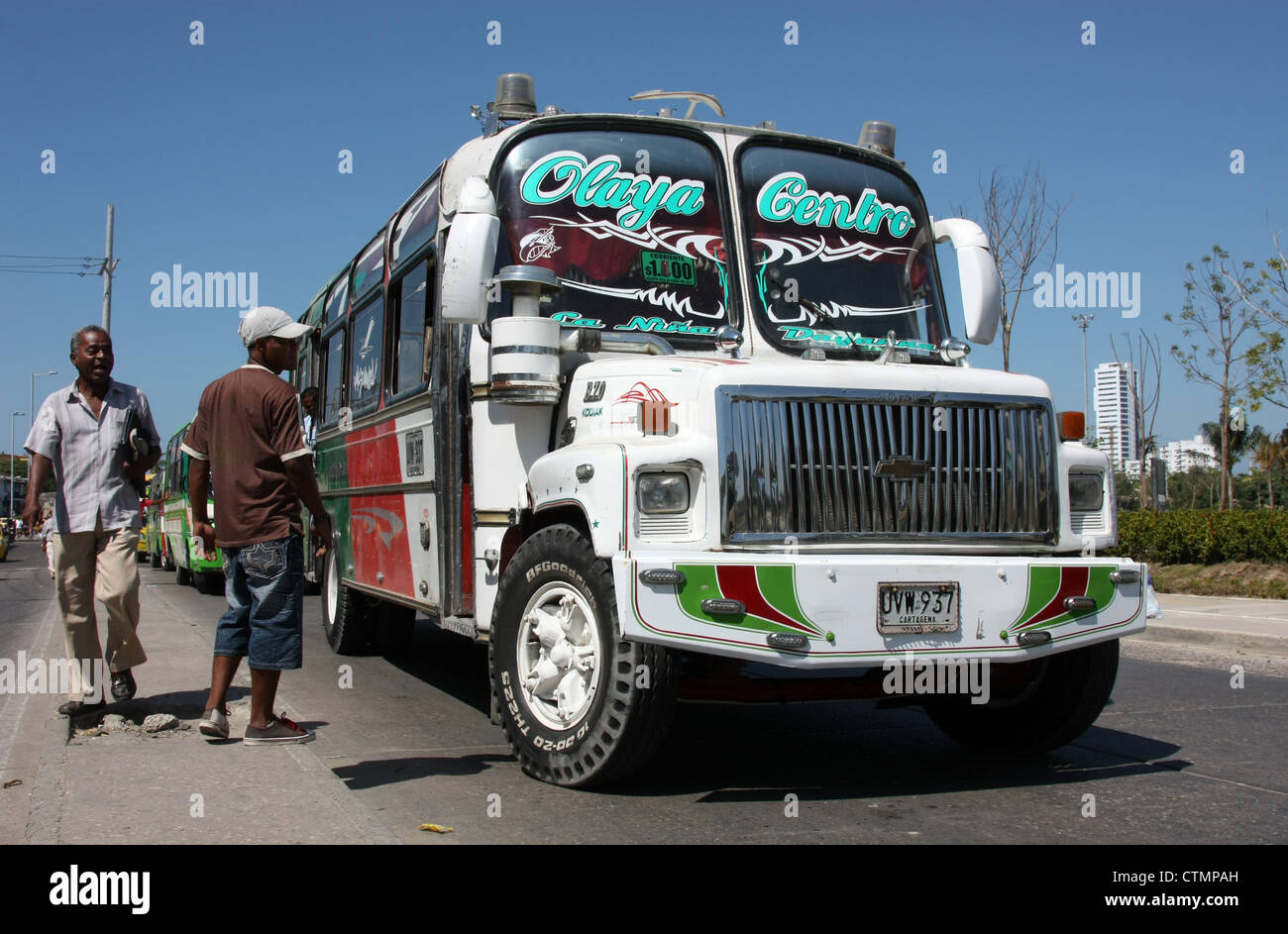 Brightly decorated local bus (chicken bus) picking up passengers in Old ...