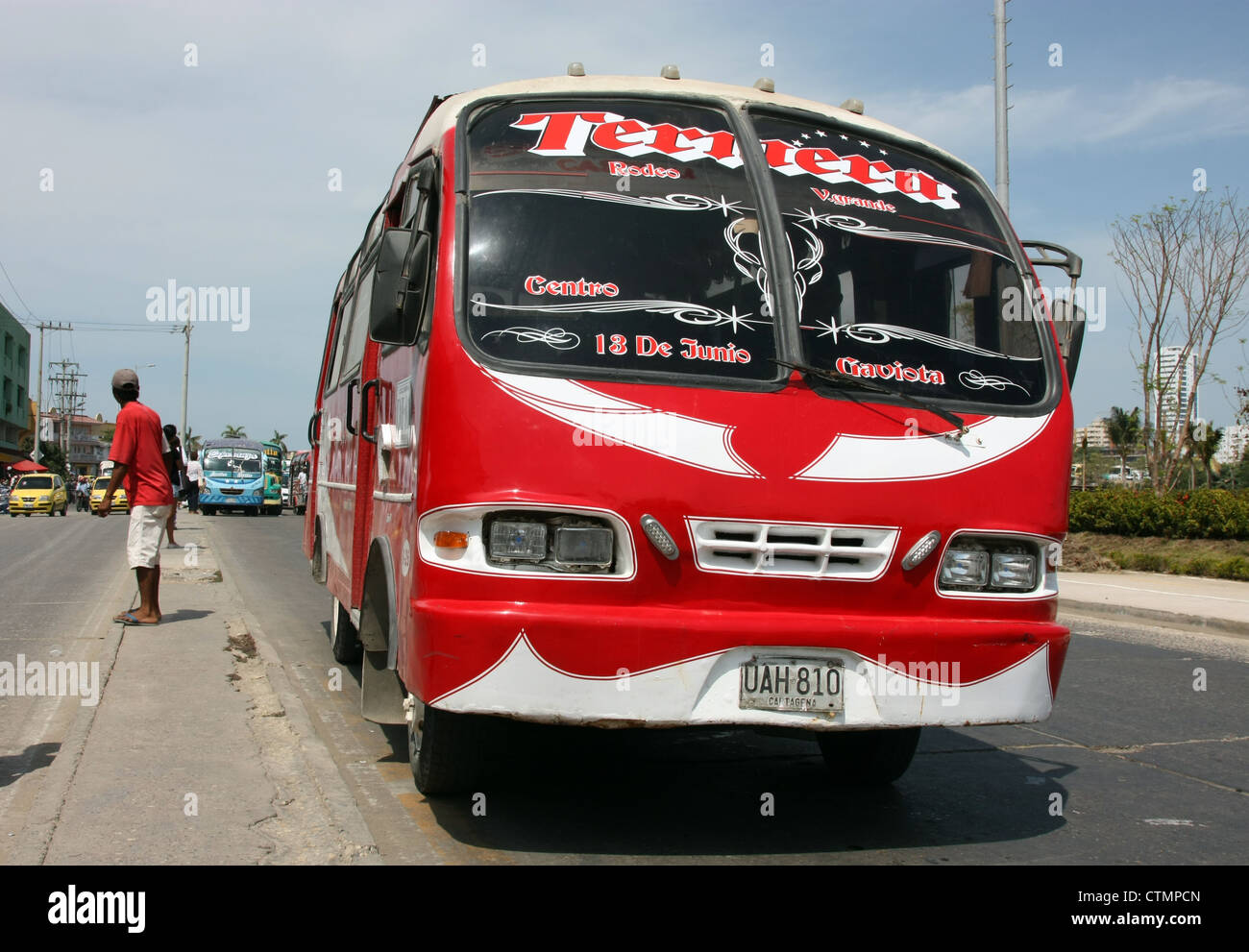 Brightly decorated local bus (chicken bus) picking up passengers in Old ...