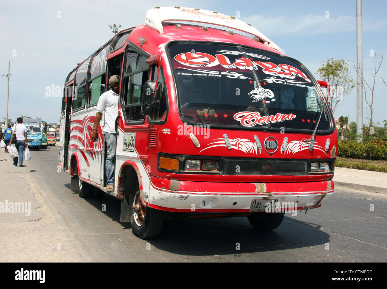Brightly decorated local bus (chicken bus) picking up passengers in Old ...
