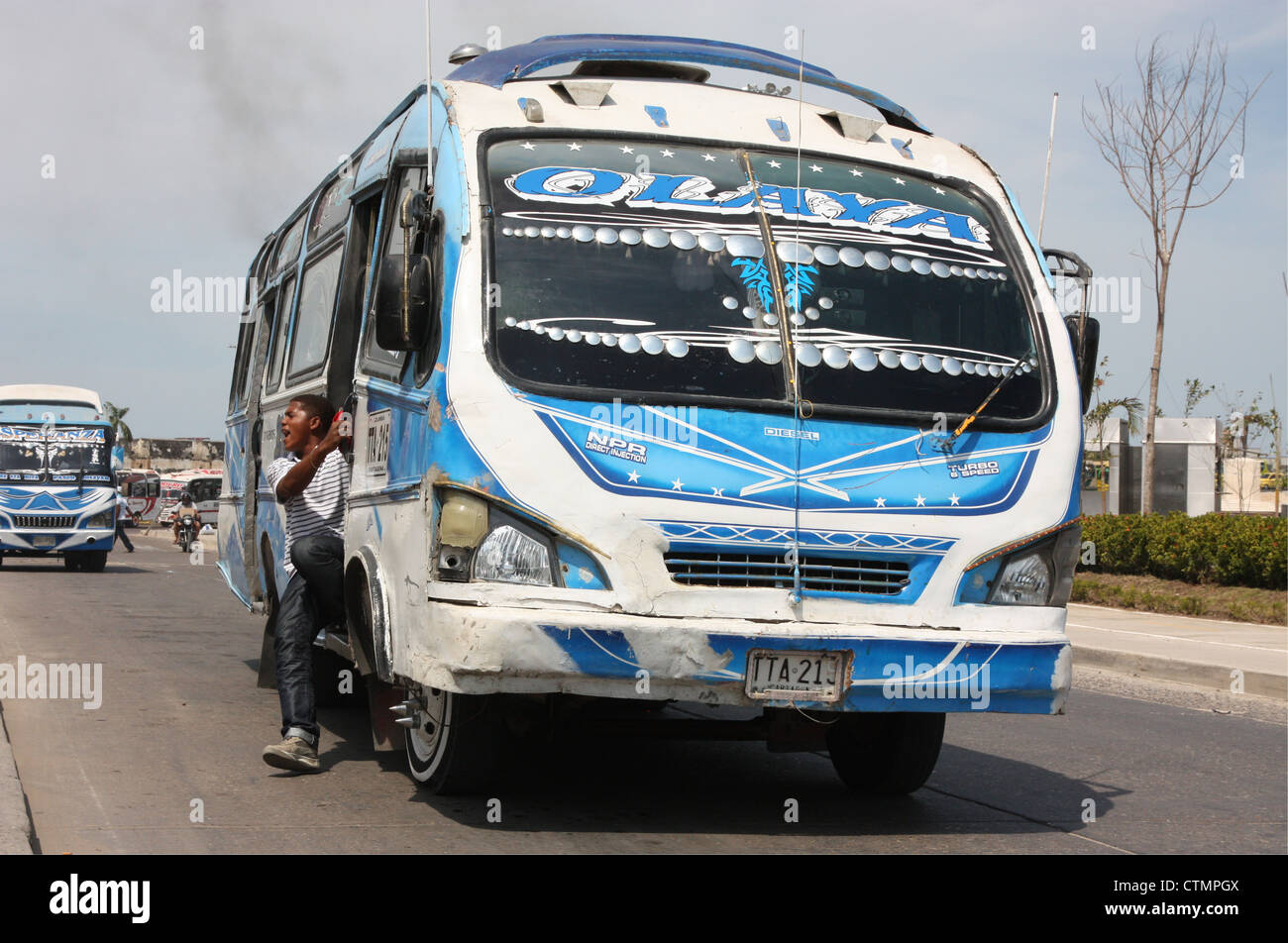 Brightly decorated local bus (chicken bus) picking up passengers in Old ...