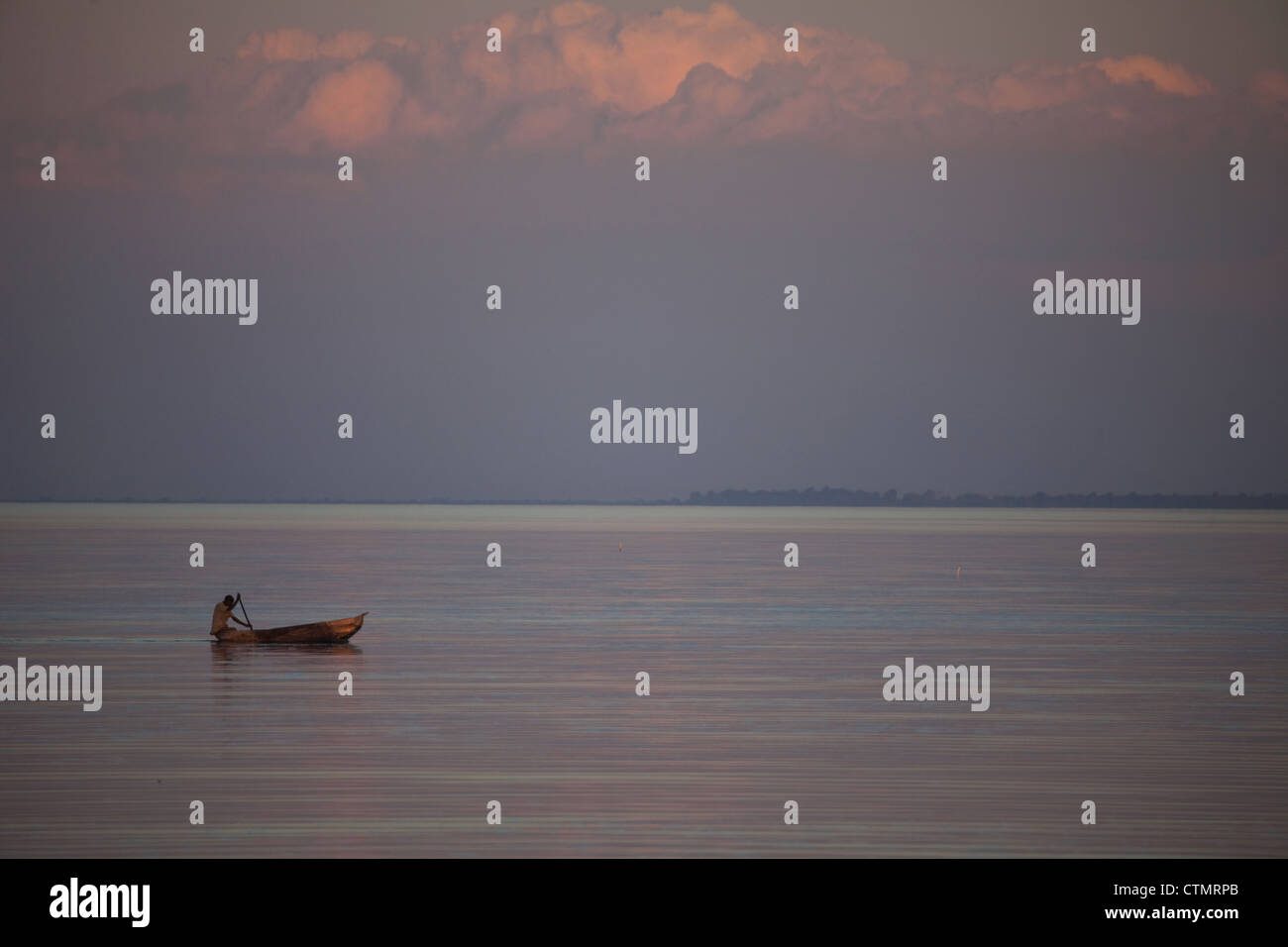 Samfia beach, Fisherman checking his nets from dugout canoe, Lake ...