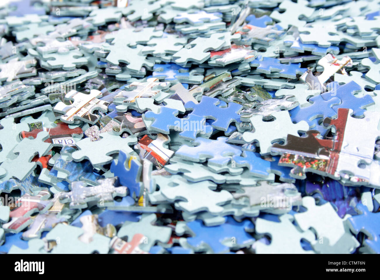 Pieces of puzzle spilled on table abstract background Stock Photo - Alamy