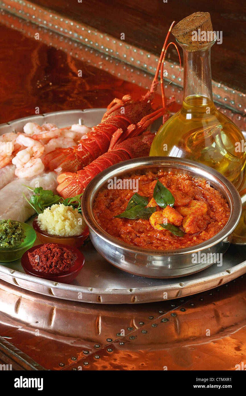 Indian cooking. Goan seafood curry made with tiger prawns, kingklip and ...