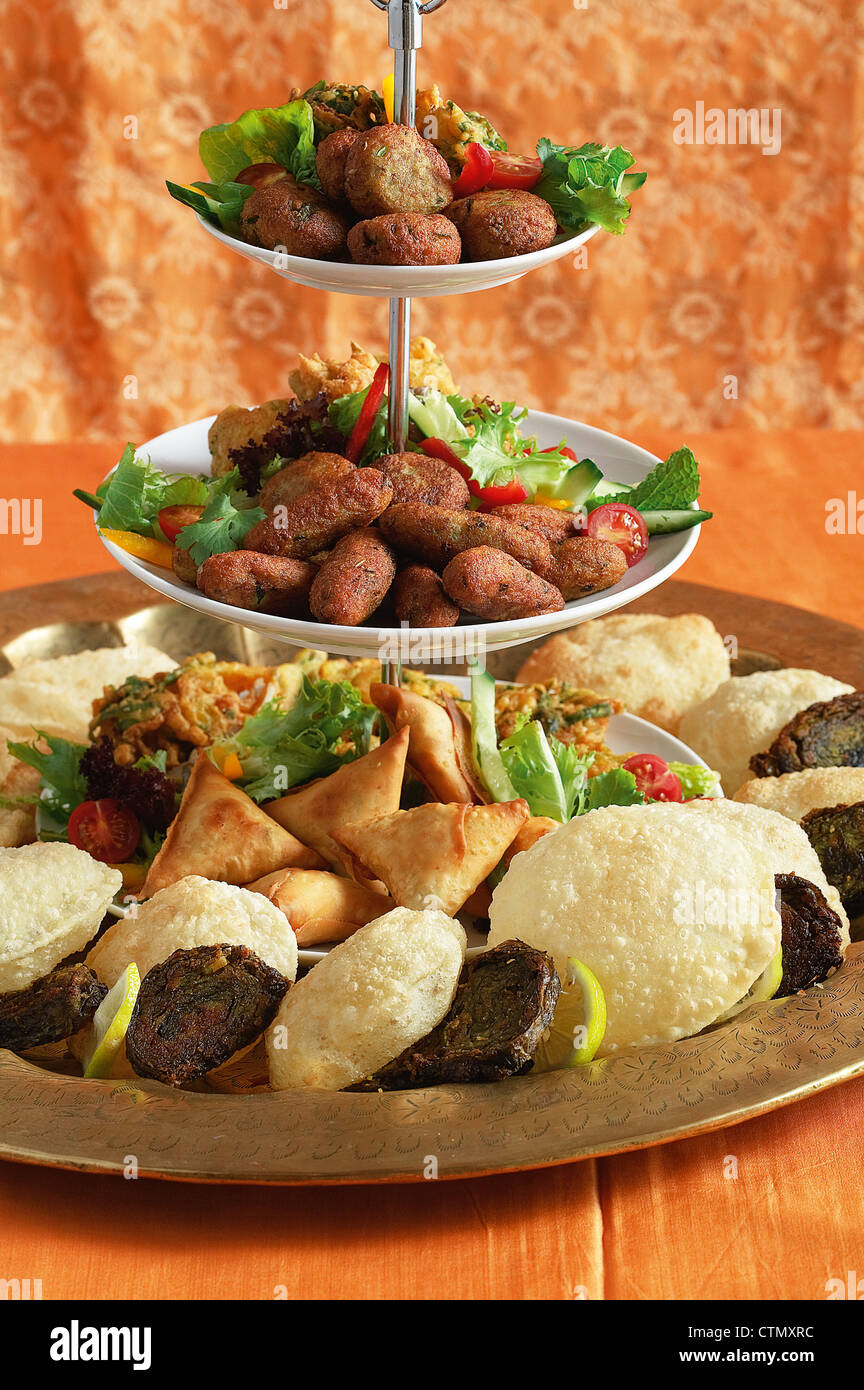 Indian cooking. A platter of snacks. Potato croquettes, samoosas, puri ...