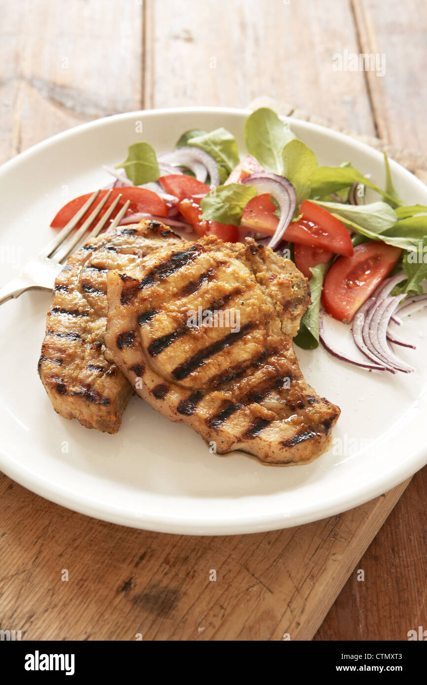 Traditional Karoo cooking. Curried pork chops served with a fresh salad ...