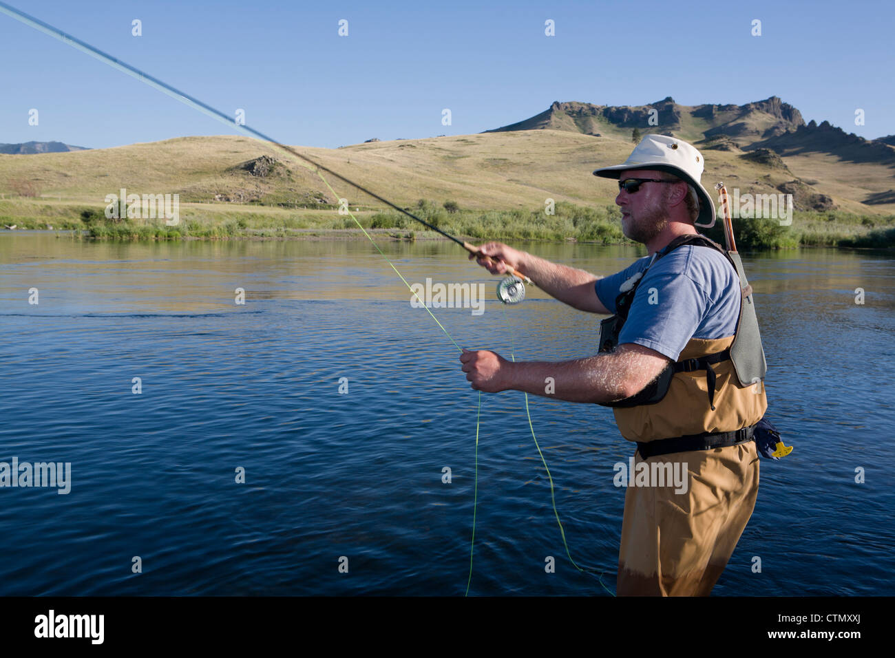 A fly fisherman casts to trout on the Missouri River at Pelican Point ...