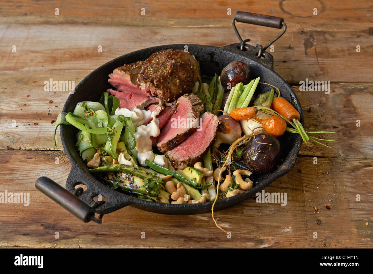 Traditional African cooking. Spiced beef fillet served with assorted ...