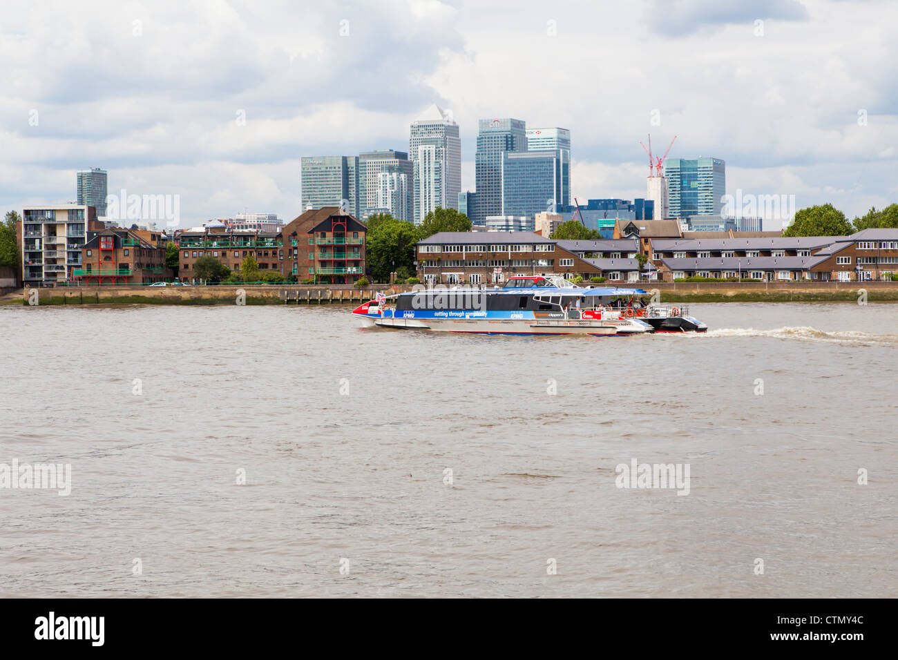 Thames clipper with Canary Wharf in the background Stock Photo - Alamy