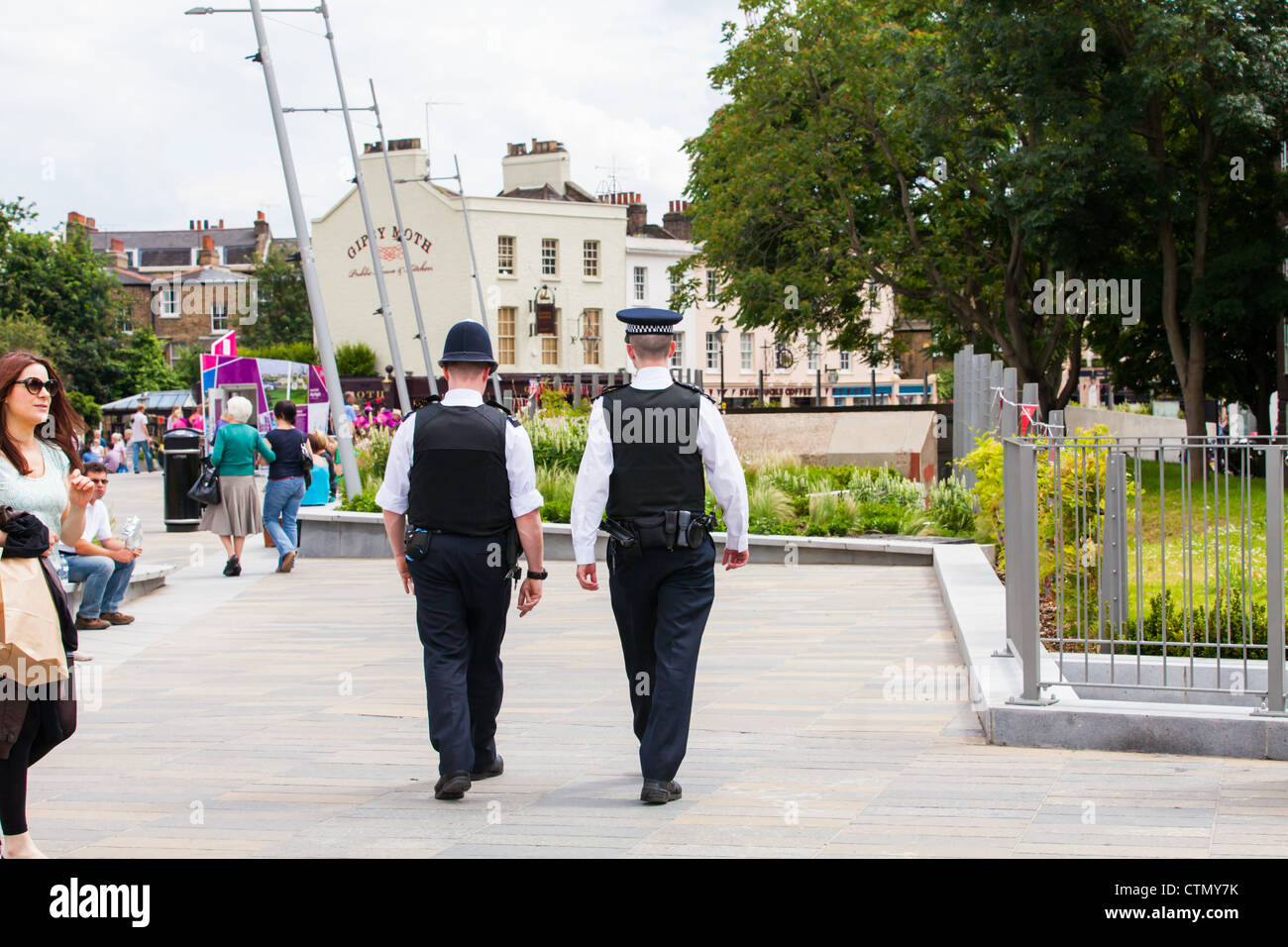 Two male police officers walking Stock Photo - Alamy