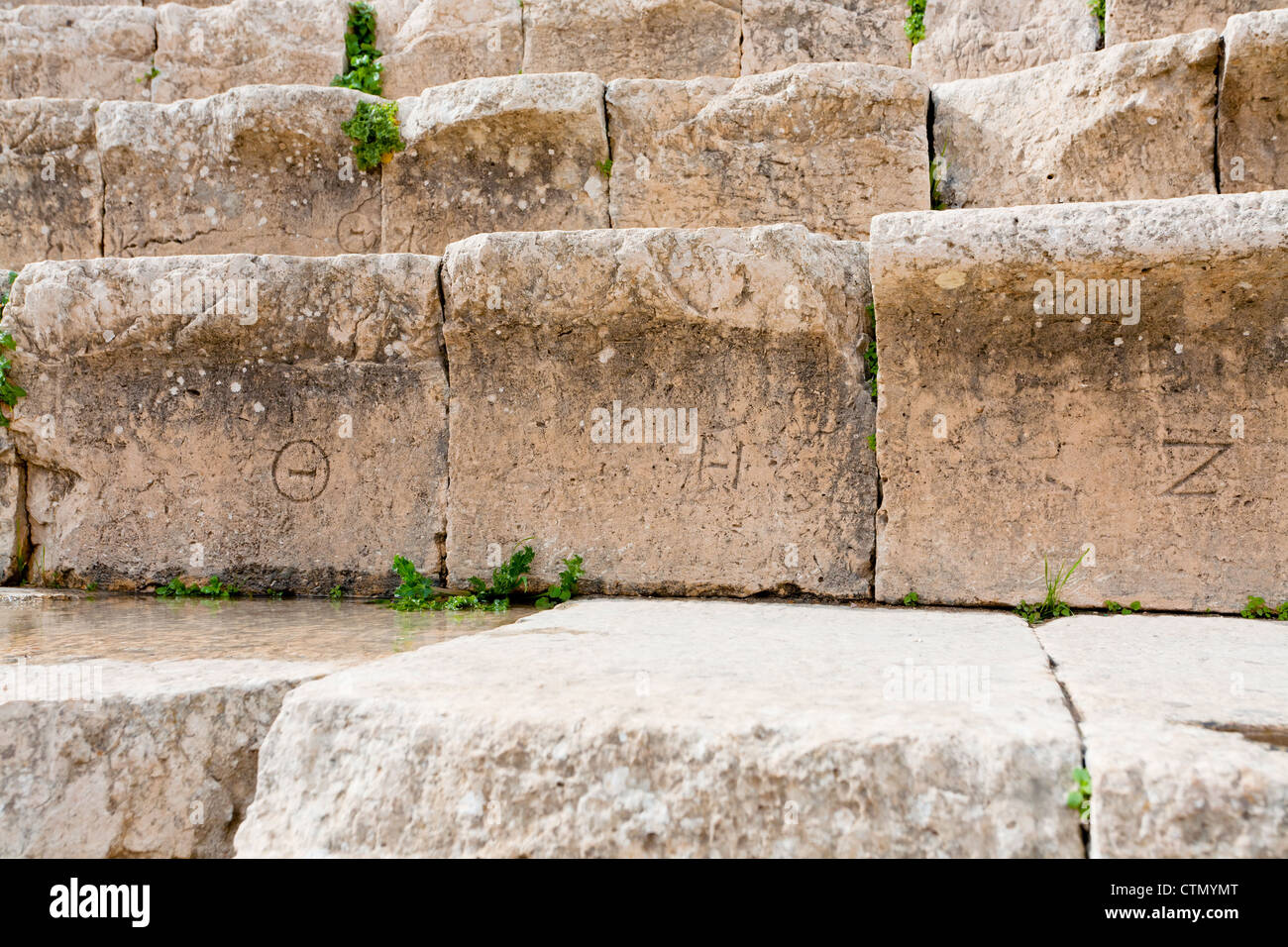 ancient greek numbers on stone seats in antique Large South Theatre ...