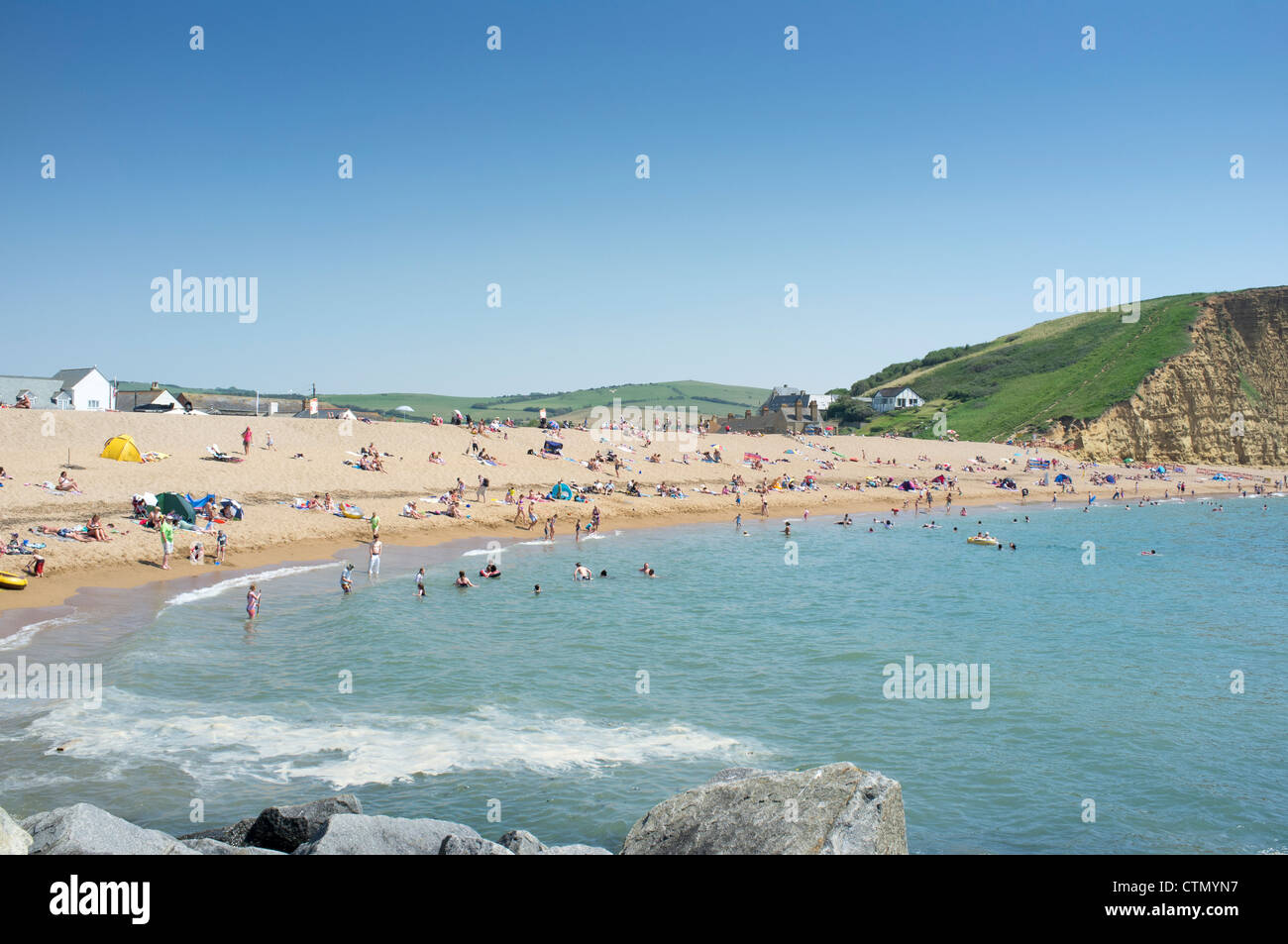People on the beach at West Bay on the Dorset coast UK Stock Photo - Alamy