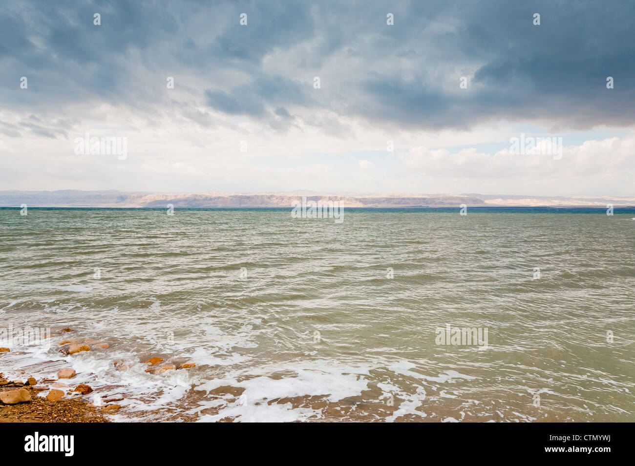pink sunrise with grey clouds on Dead Sea coast Stock Photo - Alamy