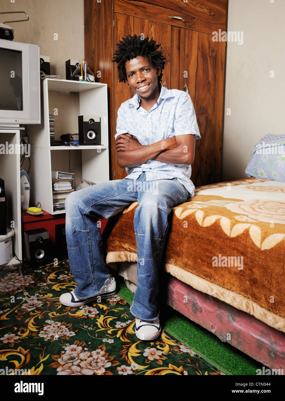 Portrait of an African man in his bedroom, Gugulethu, Cape Town Stock ...