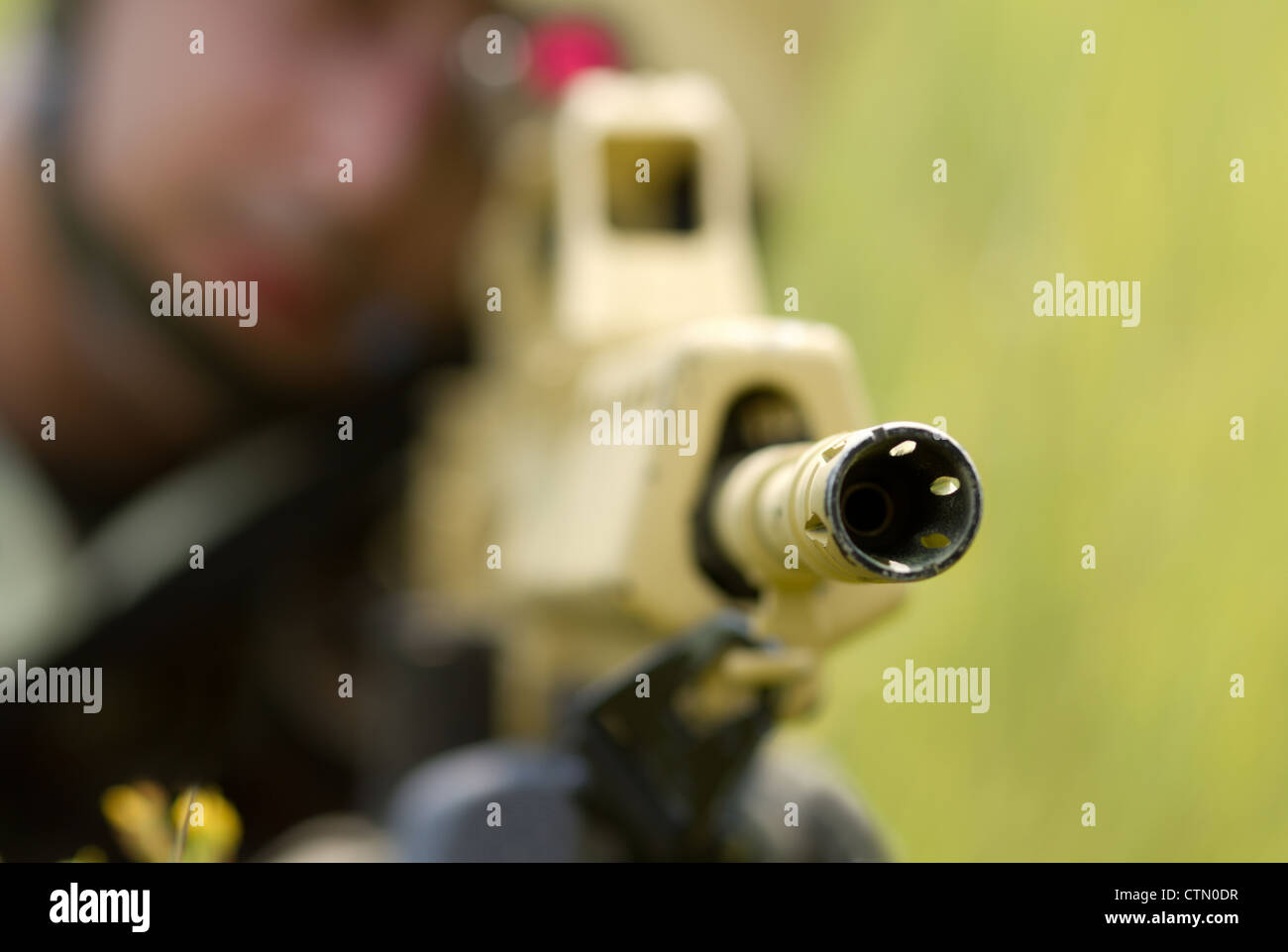 Young soldier with automatic rifle and combat ammunition outdoors Stock ...