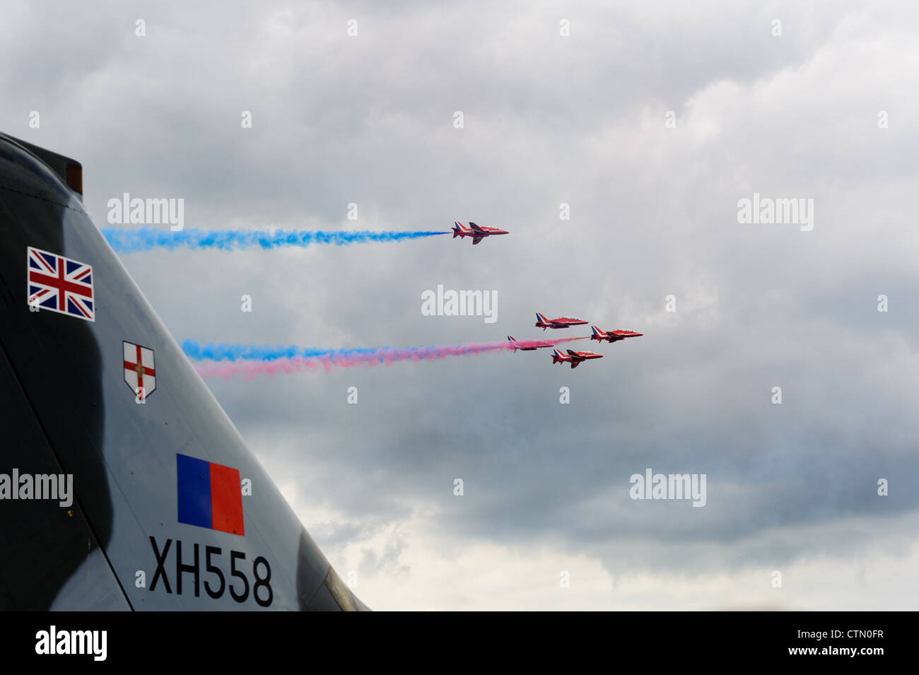 The Red Arrows fly over the tail of the last flying Vulcan bomber Stock ...
