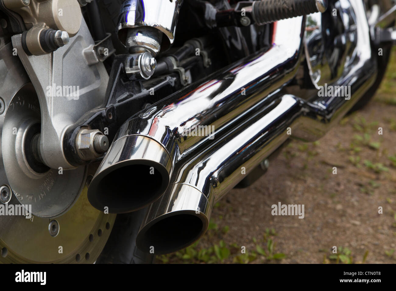 Bike chromed double pipes are reflecting sun light Stock Photo - Alamy