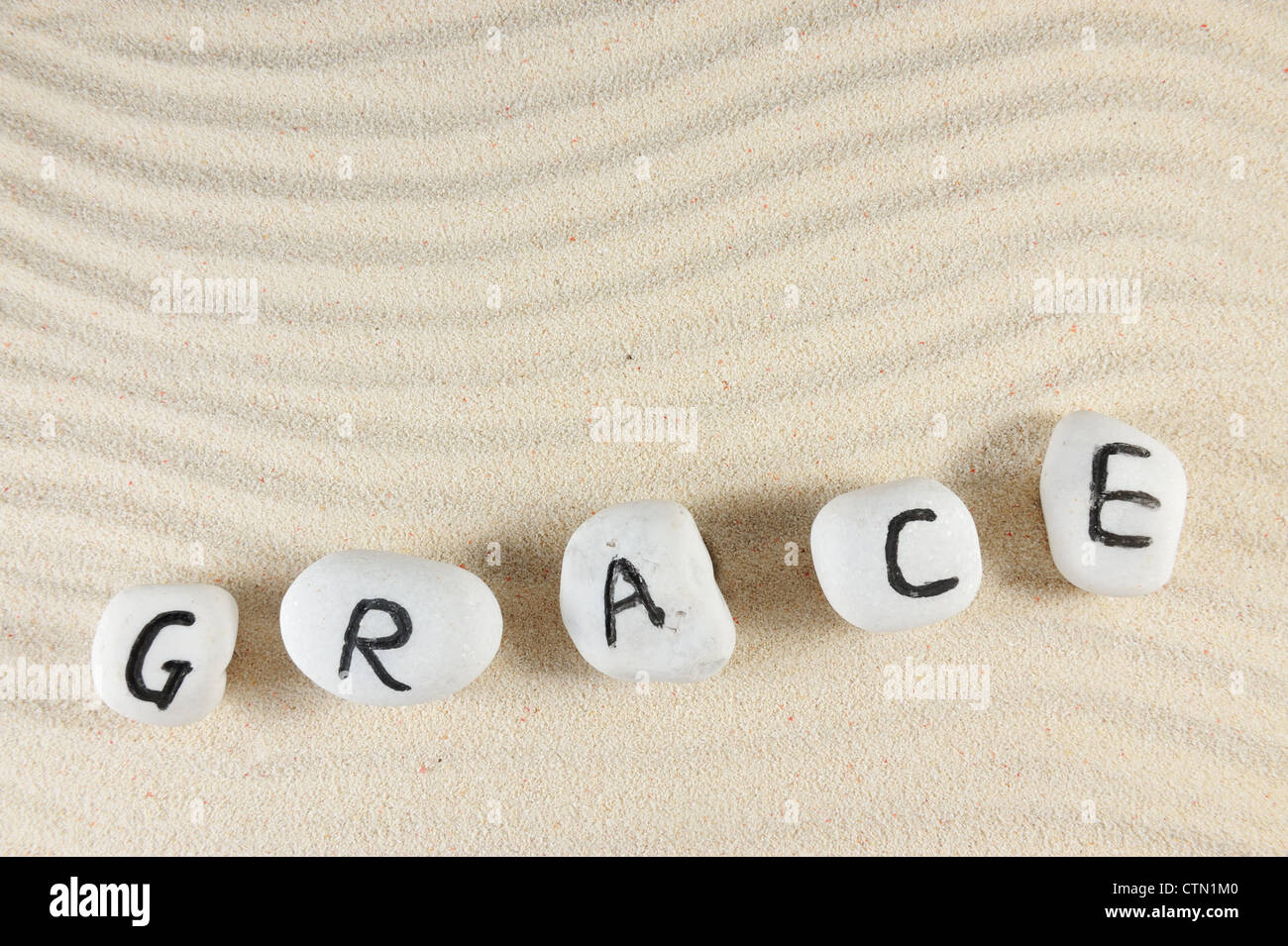 Grace word on group of stones with sand background Stock Photo - Alamy