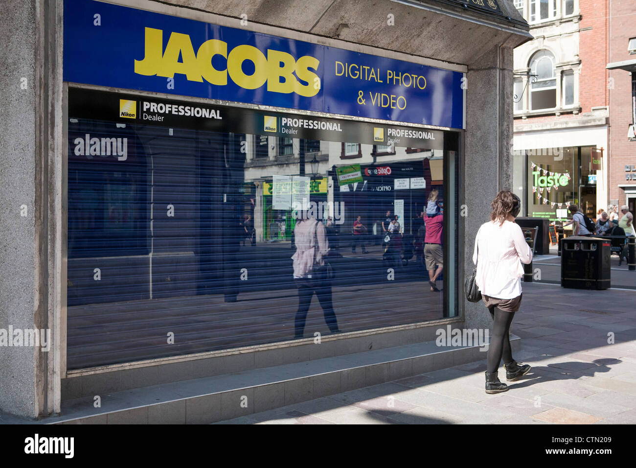 A woman walks past the closed Jacobs photo shop in Cardiff. Jacobs went ...
